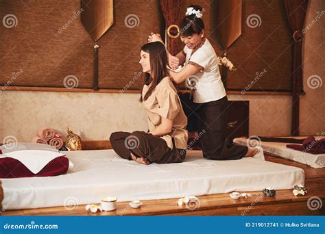 Massage Therapist Twisting Woman Arm Behind Her Back Stock Image Image Of Relaxing Exercise