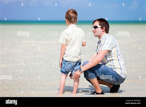 Father And Son At Shallow Water Stock Photo Alamy
