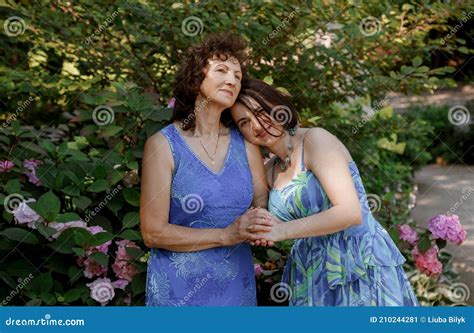 Happy Woman Have Fun In Evening Gown Mom And Her Daughter Laughing And Walking At The Park Two