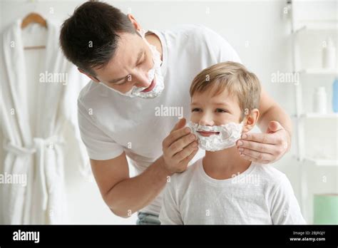 Father And Son Shaving Together In Bathroom Stock Photo Alamy