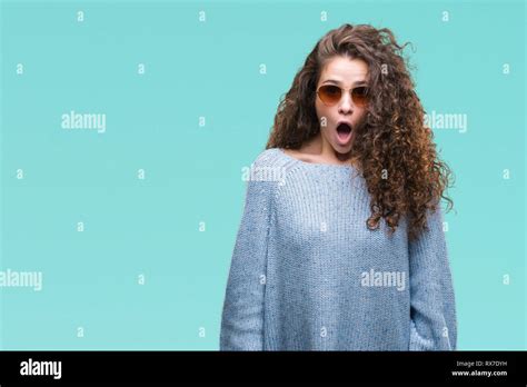 Beautiful Brunette Curly Hair Young Girl Wearing Sunglasses Over Isolated Background Afraid And