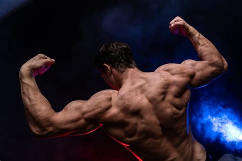 Premium Photo Muscular Man Showing Muscles Isolated On The Black