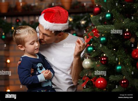 Father Kissing Son Near Pine Stock Photo Alamy